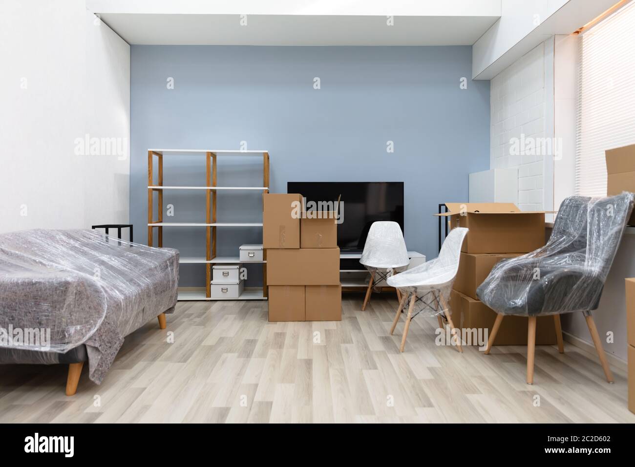 Living Room Interior Of New House With Moving Boxes Stock Photo - Alamy