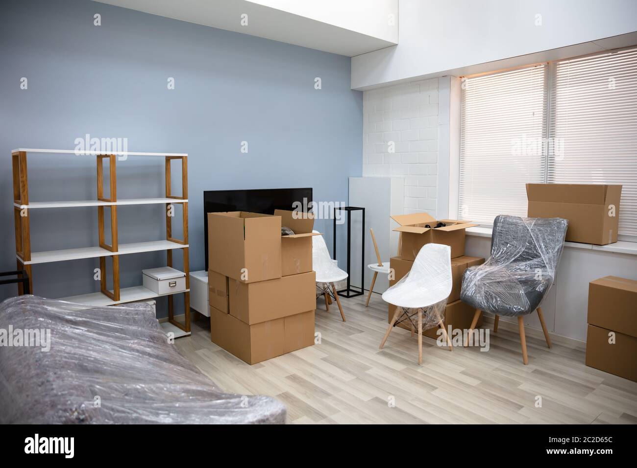 Living Room Interior Of New House With Moving Boxes Stock Photo - Alamy