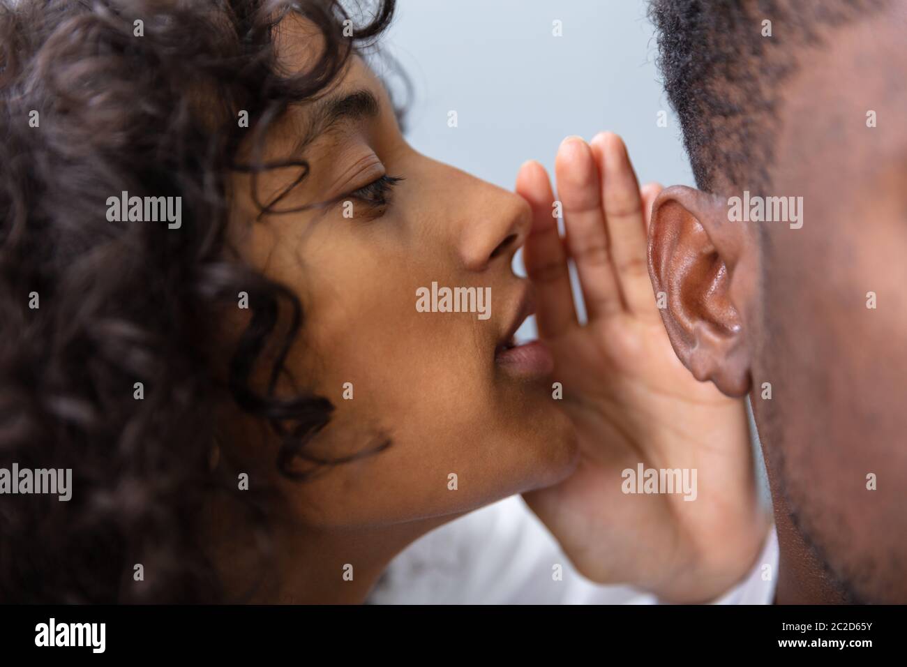Speaking in his ear hi-res stock photography and images - Alamy