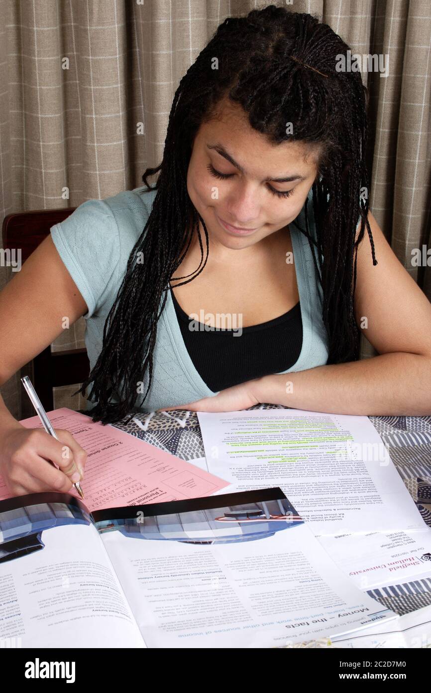 Young woman making paper application for university Stock Photo - Alamy