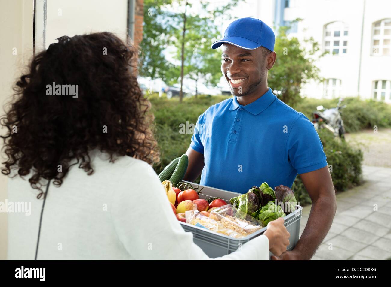 Women delivering groceries to man hi-res stock photography and images ...