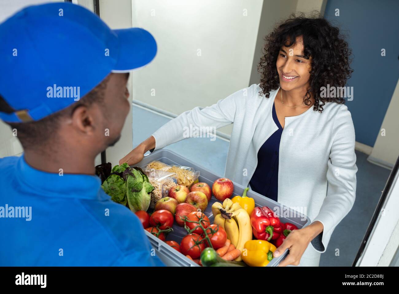 Women delivering groceries to man hi-res stock photography and images ...