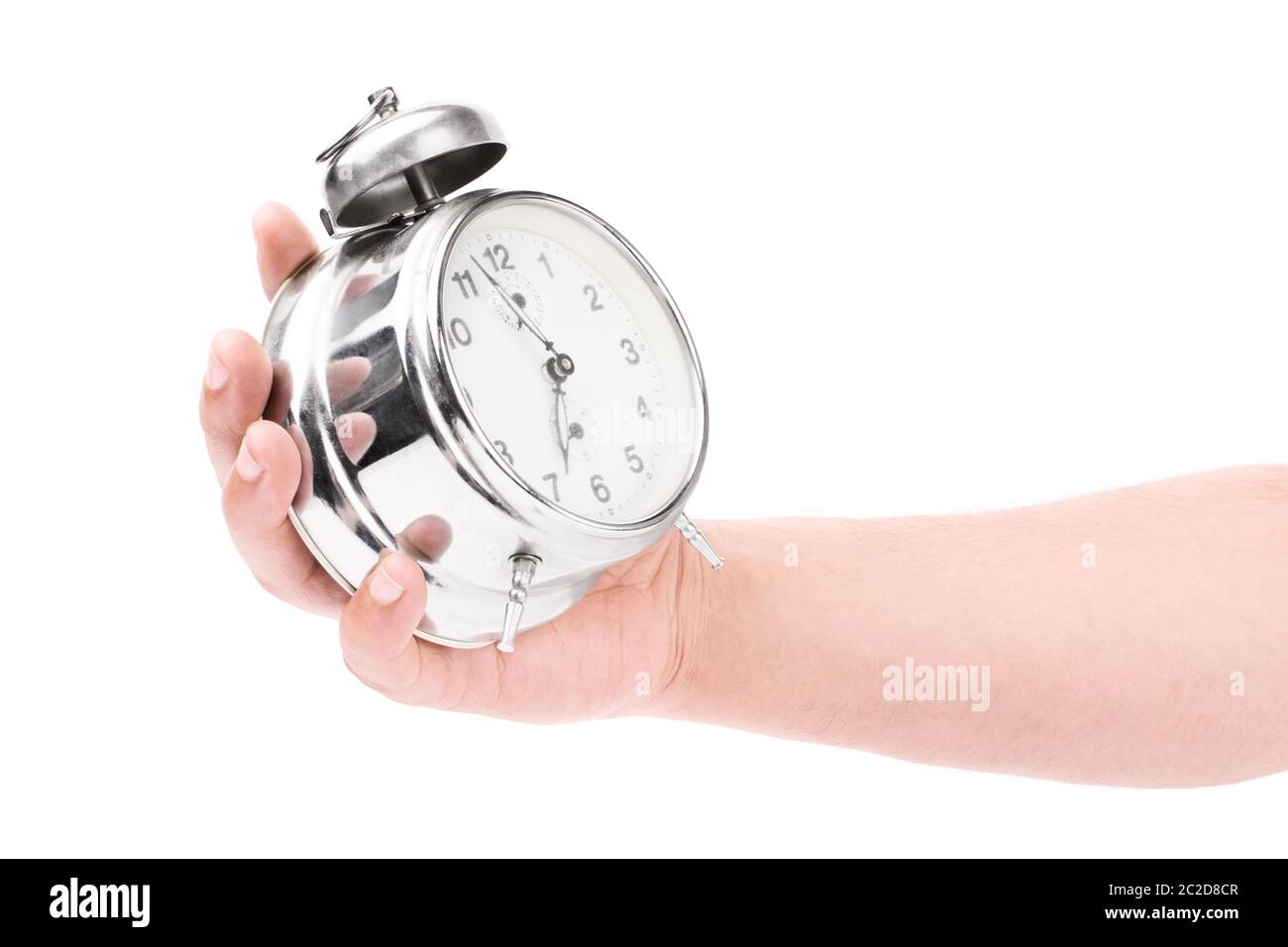 Male hand holding an old fashioned alarm clock, isolated on white ...