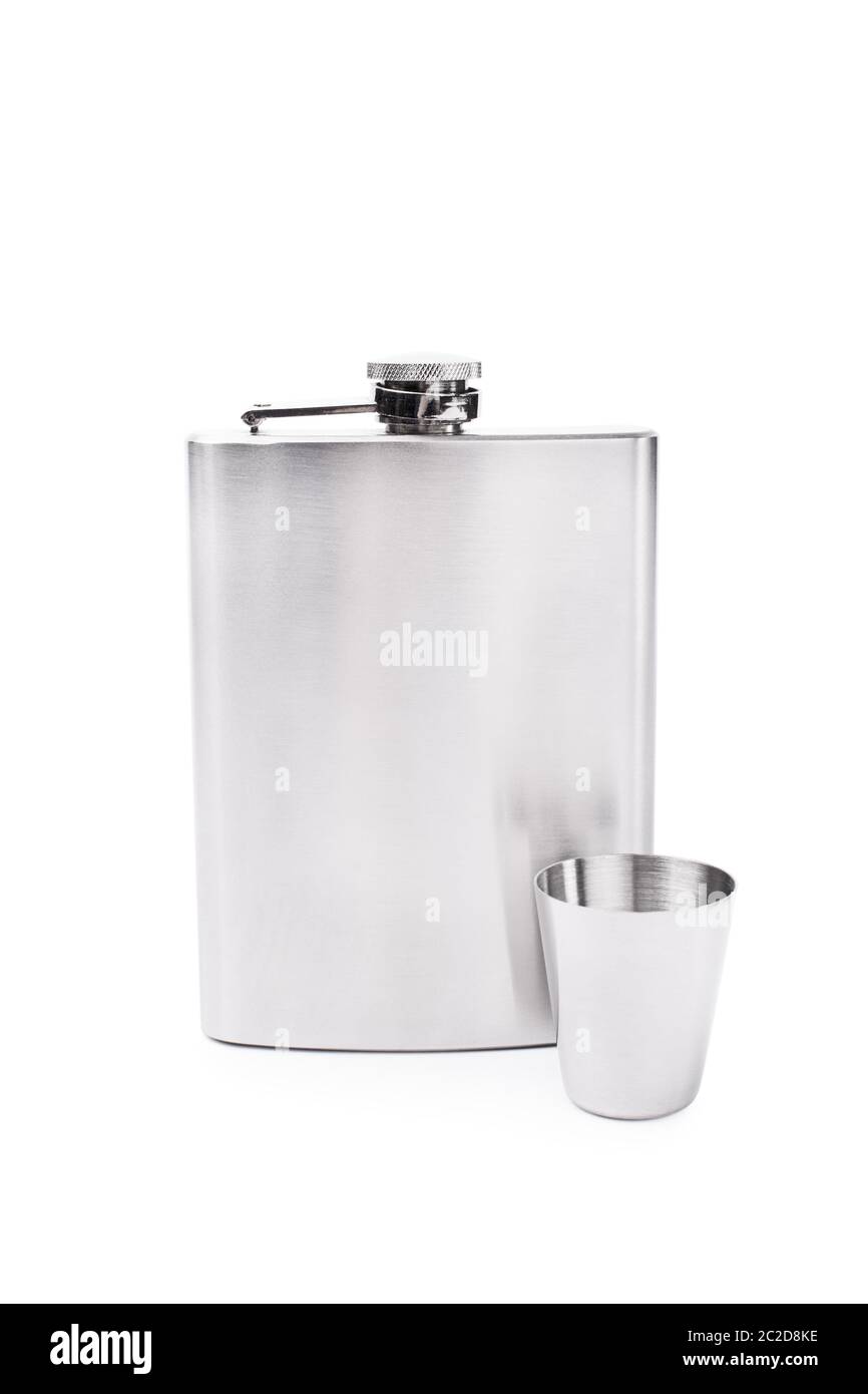 Stainless steel flask with a small metal cup, placed next to each other ...