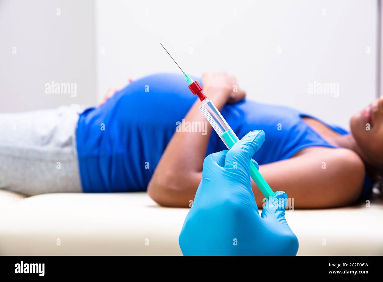 Doctor Preparing Vaccine Injection For Pregnant Woman At Clinic Stock ...