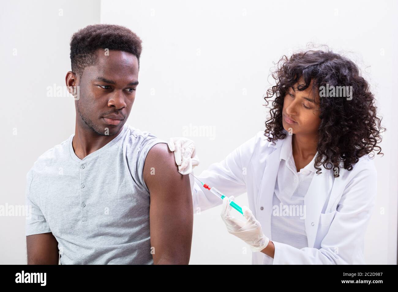 Close-up Of Doctor Injecting Vaccine Into Patients Arm With Syringe ...