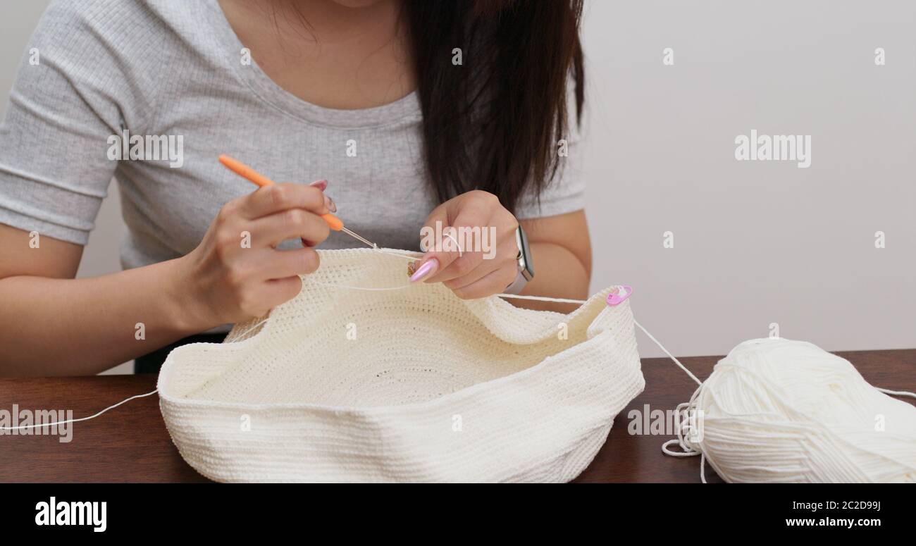 Woman knitter making fabric from thread Stock Photo - Alamy