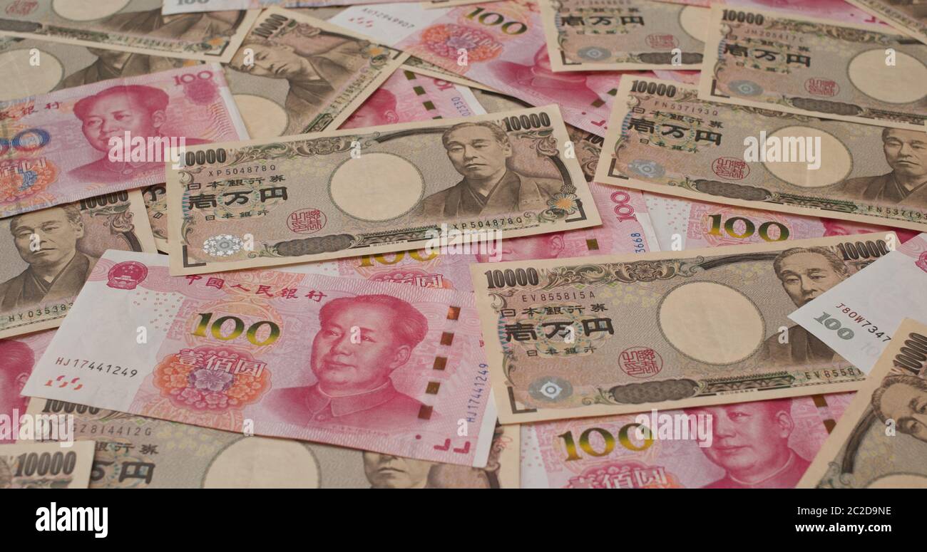 Stack of Chinese banknote and Japanese Yen Stock Photo - Alamy