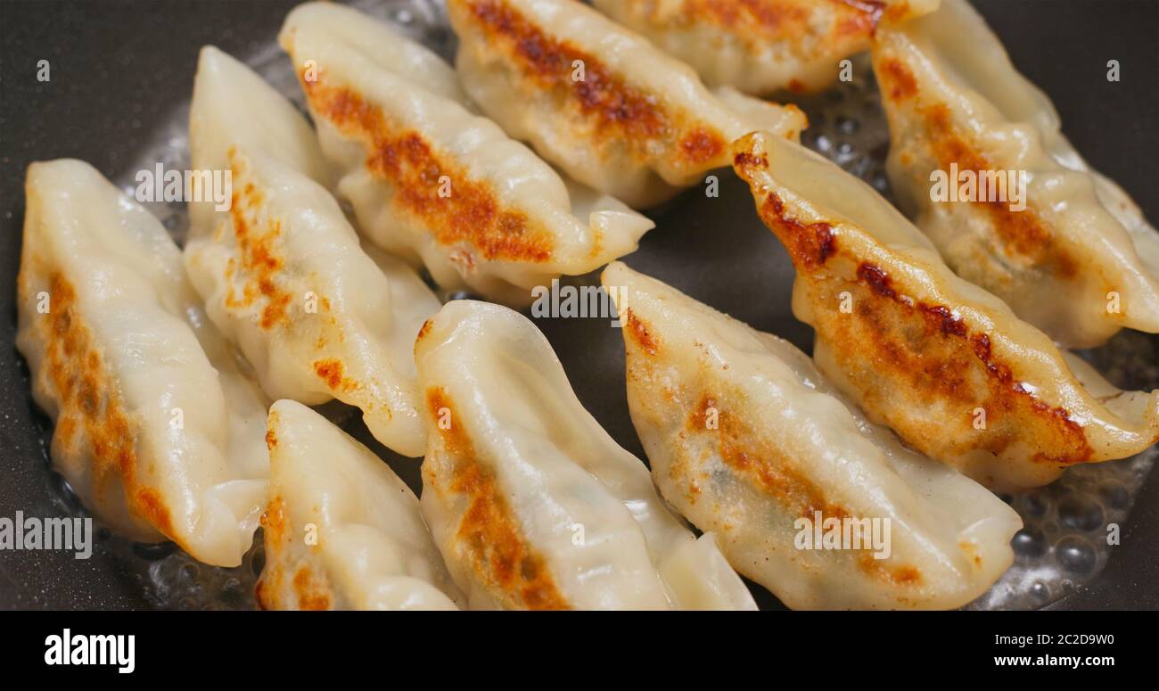 Fry Meat dumpling in pan Stock Photo - Alamy