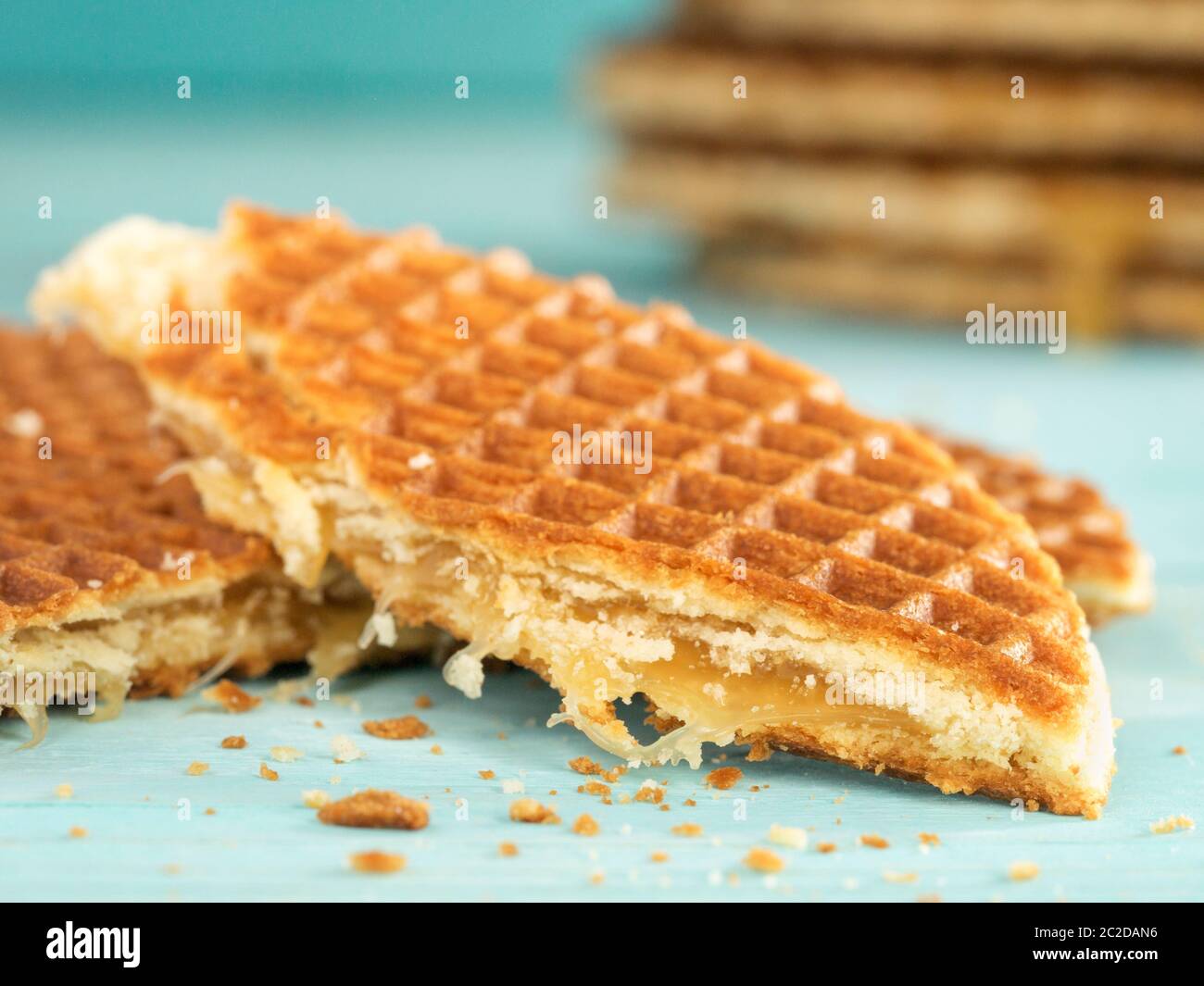 Stroopwafels or caramel Dutch Waffle close up on turquoise wooden ...