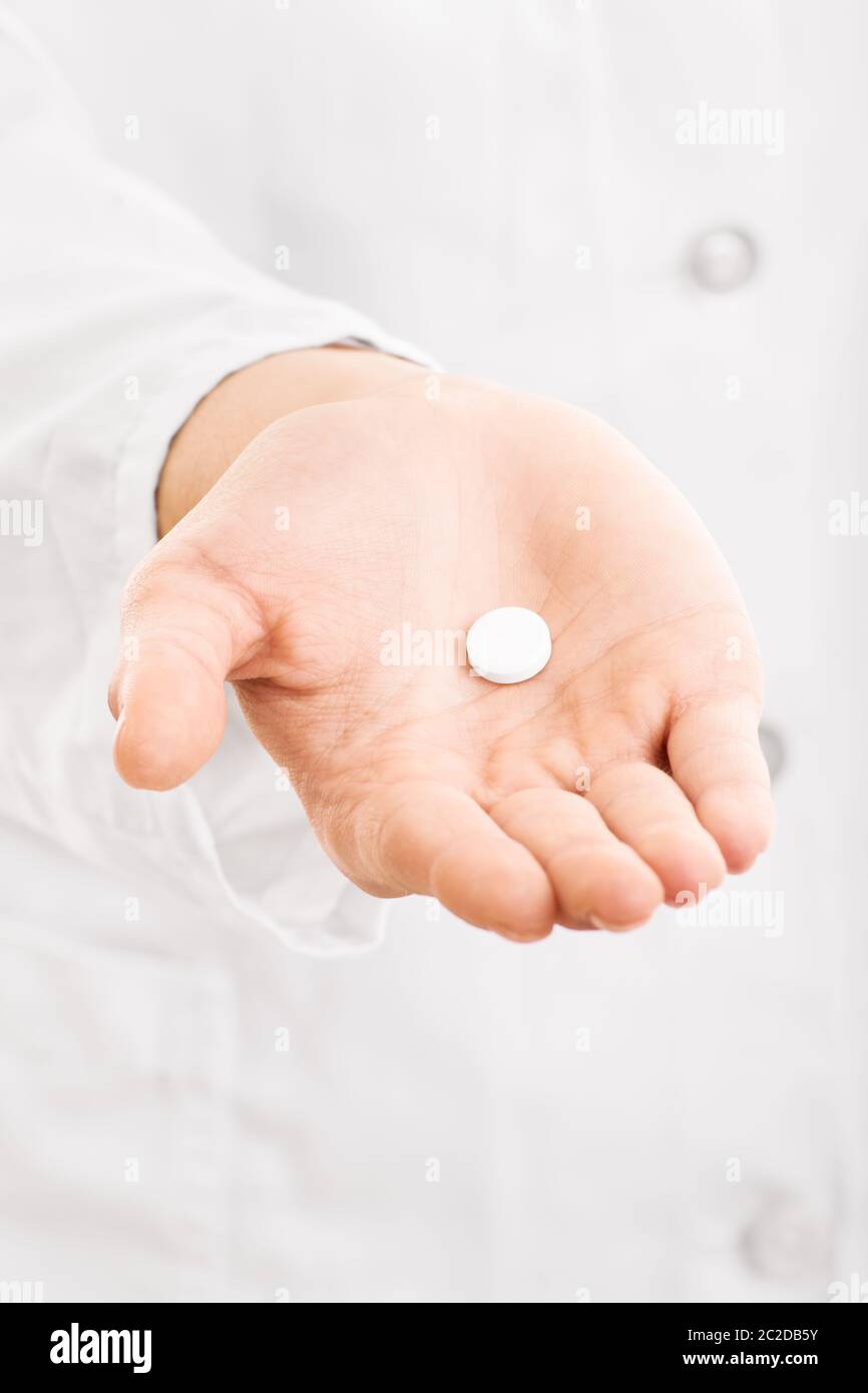 Have this and get better. Doctor's hand handing out a pill Stock Photo ...