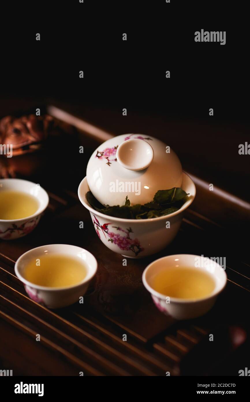 Chinese tea ceremony. Porcelain gaiwan, three cups of Chinese tea and ...