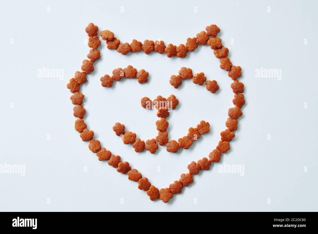 cat food arranging smiling face on white background Stock Photo - Alamy