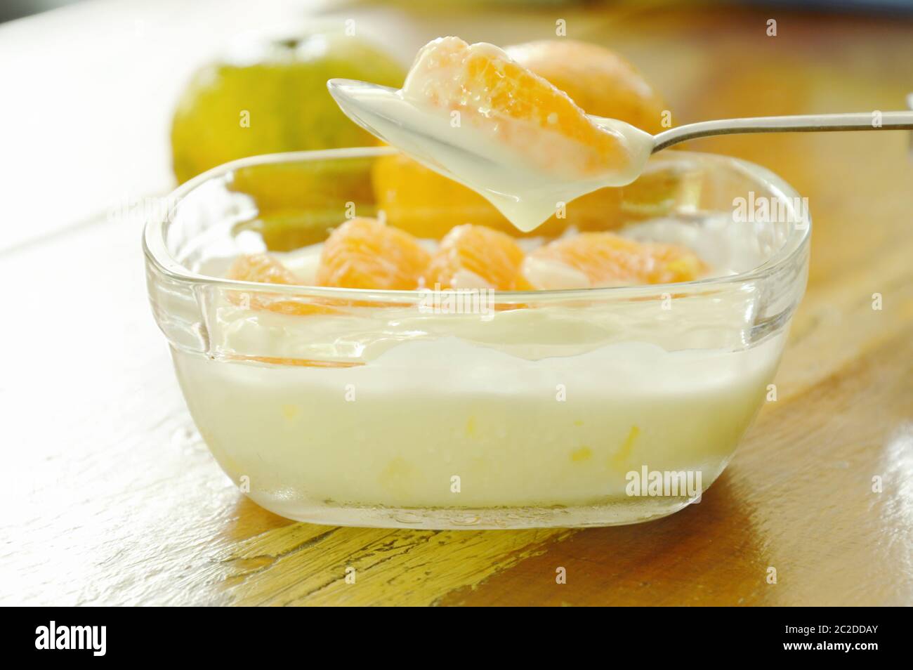 yogurt topping orange scooping on spoon in glass cup Stock Photo - Alamy