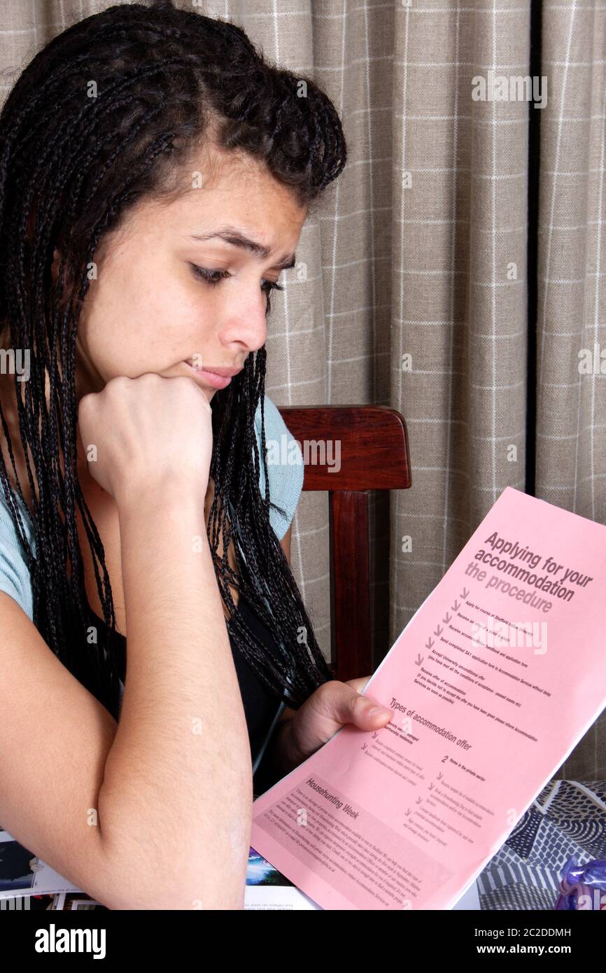 Young woman completing application forms for a place at university ...
