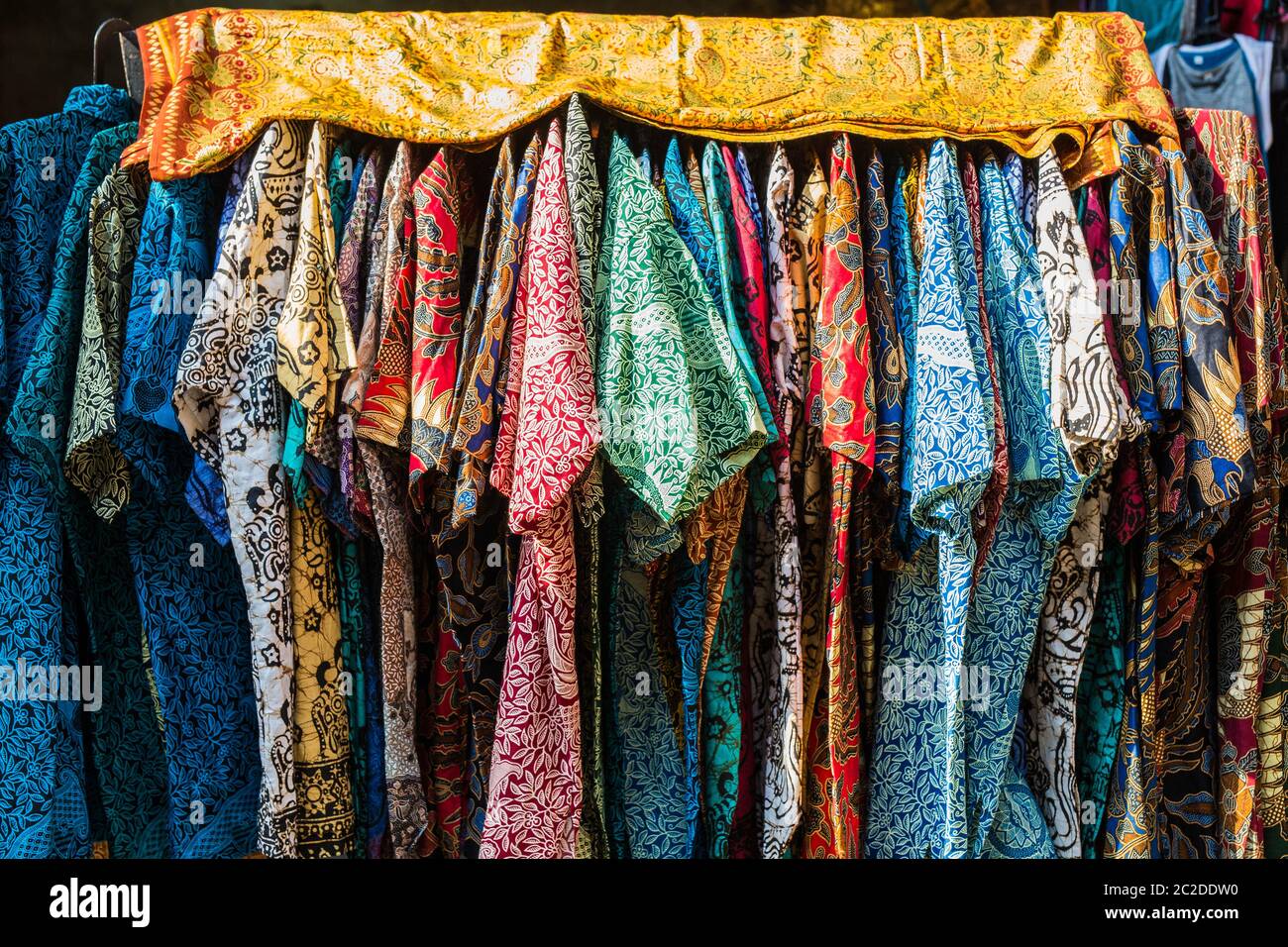 stack of traditional colourful sarong in a row on the market in ...