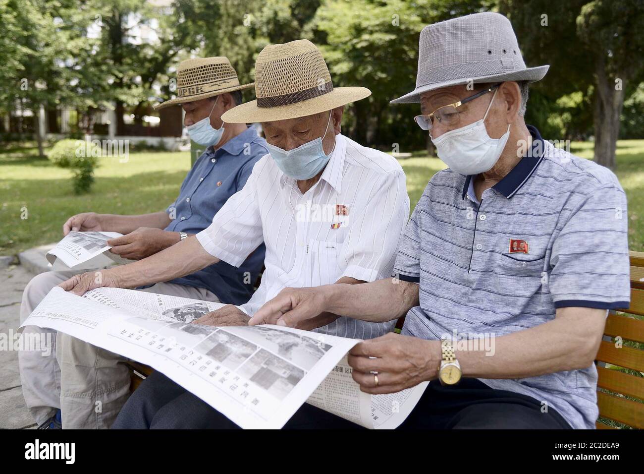 People read a Rodong Sinmun newspaper article in Pyongyang on June 17 ...