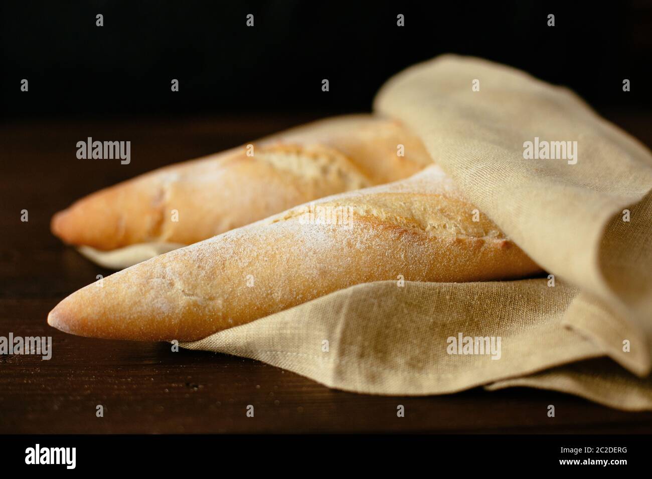 Freshly baked baguette. Two freshly baked baguette wrapped in a bakery ...