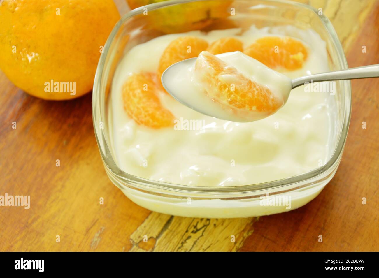 yogurt topping orange scooping on spoon in glass cup Stock Photo - Alamy
