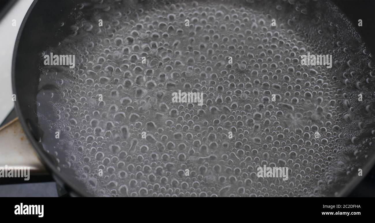 Boil water in the kitchen Stock Photo - Alamy