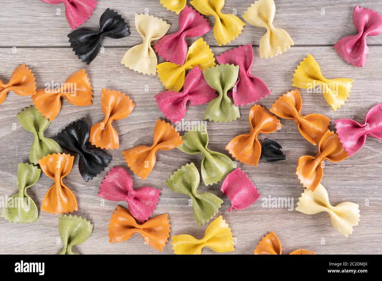 Italian pasta colored with natural dyes on the wooden table Stock Photo ...