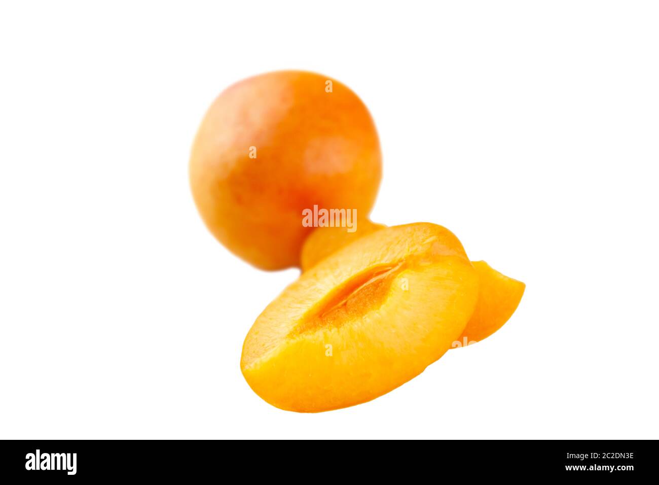 Isolated apricots. Two fresh whole apricot fruits and half isolated on ...