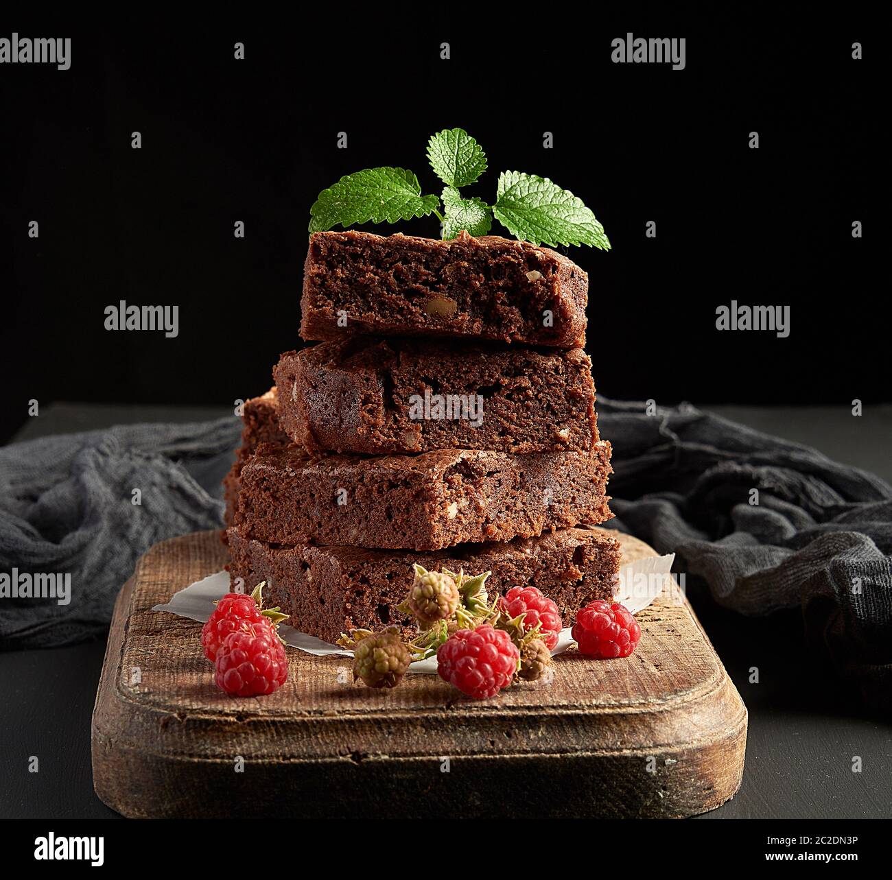 stack of baked square pieces of chocolate brownie cake on brown wooden ...