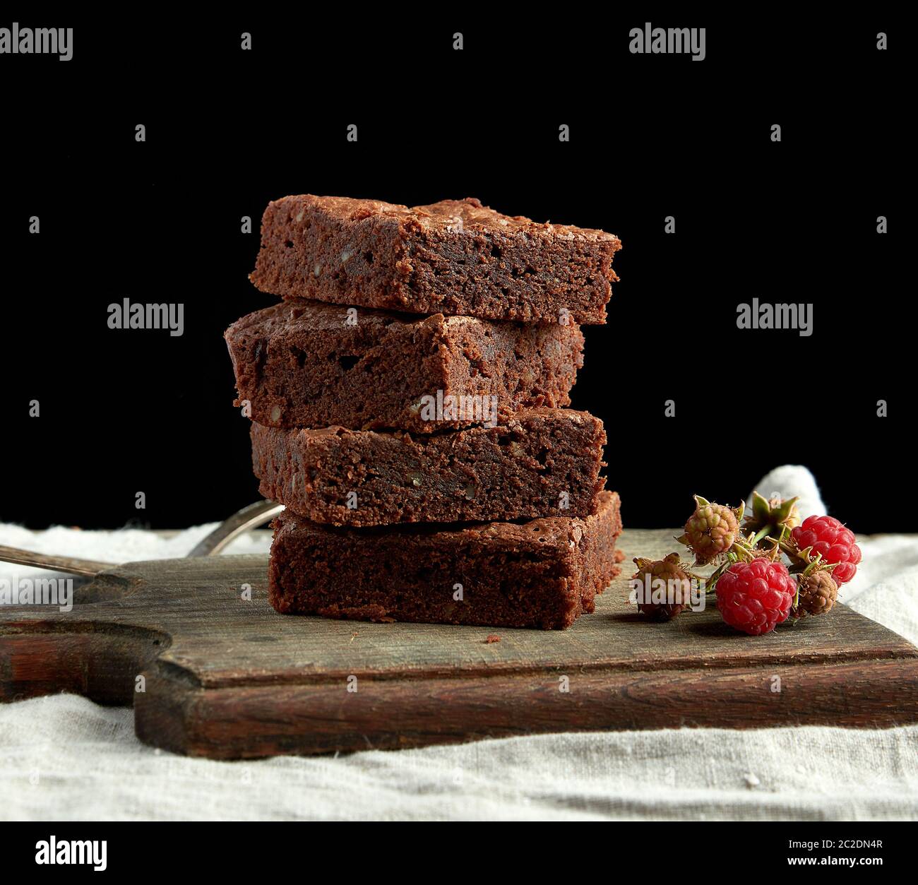 stack of baked square pieces of chocolate brownie cake on brown wooden ...
