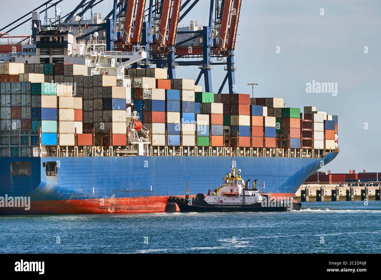 Huge container ship in port being loaded Stock Photo - Alamy