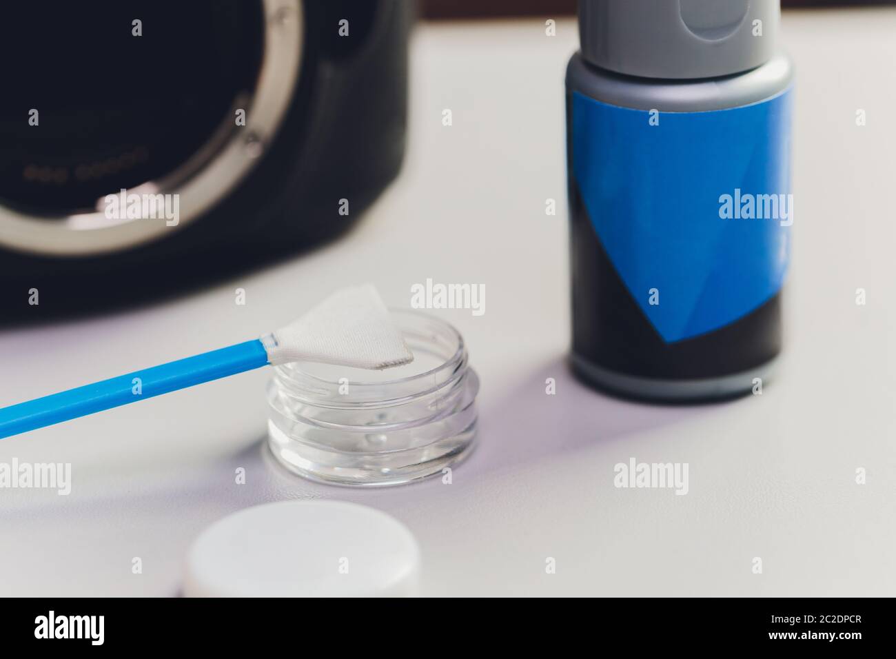 Cleaning dirty camera sensor. Digital photo camera with cleaning tools ...