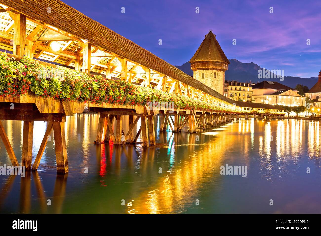 Lucerne wooden Chapel Bridge and tower colorful evening view, town in ...