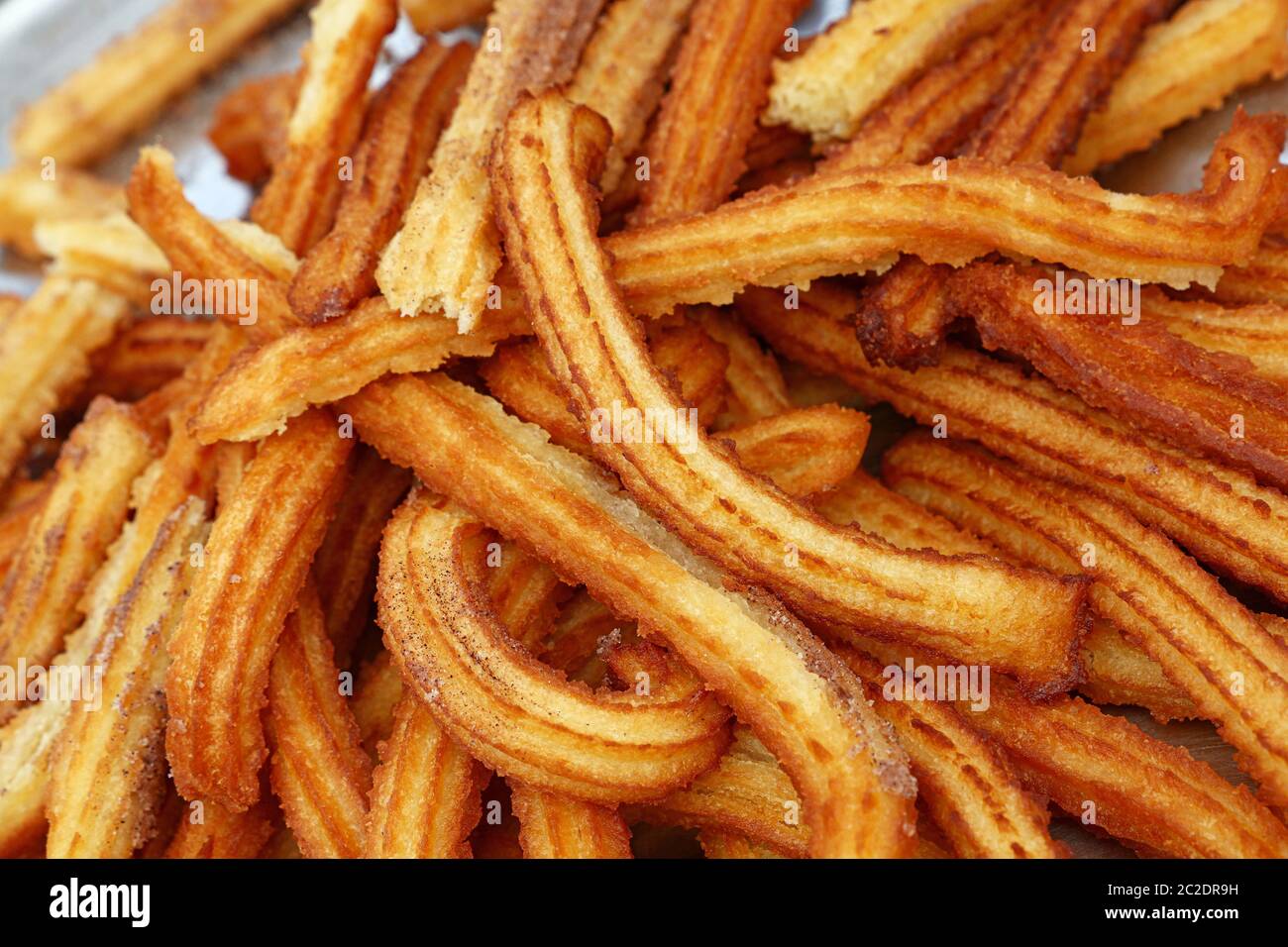 Close up tray of sweet fresh churros, traditional Spanish or Portuguese ...