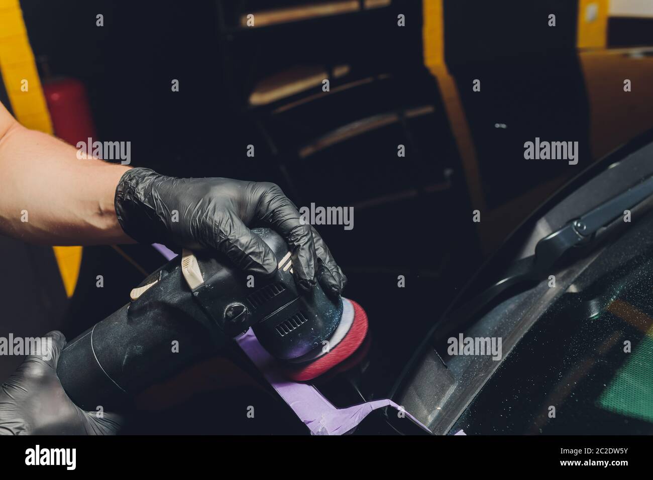 Car detailing - Hands with orbital polisher in auto repair shop ...