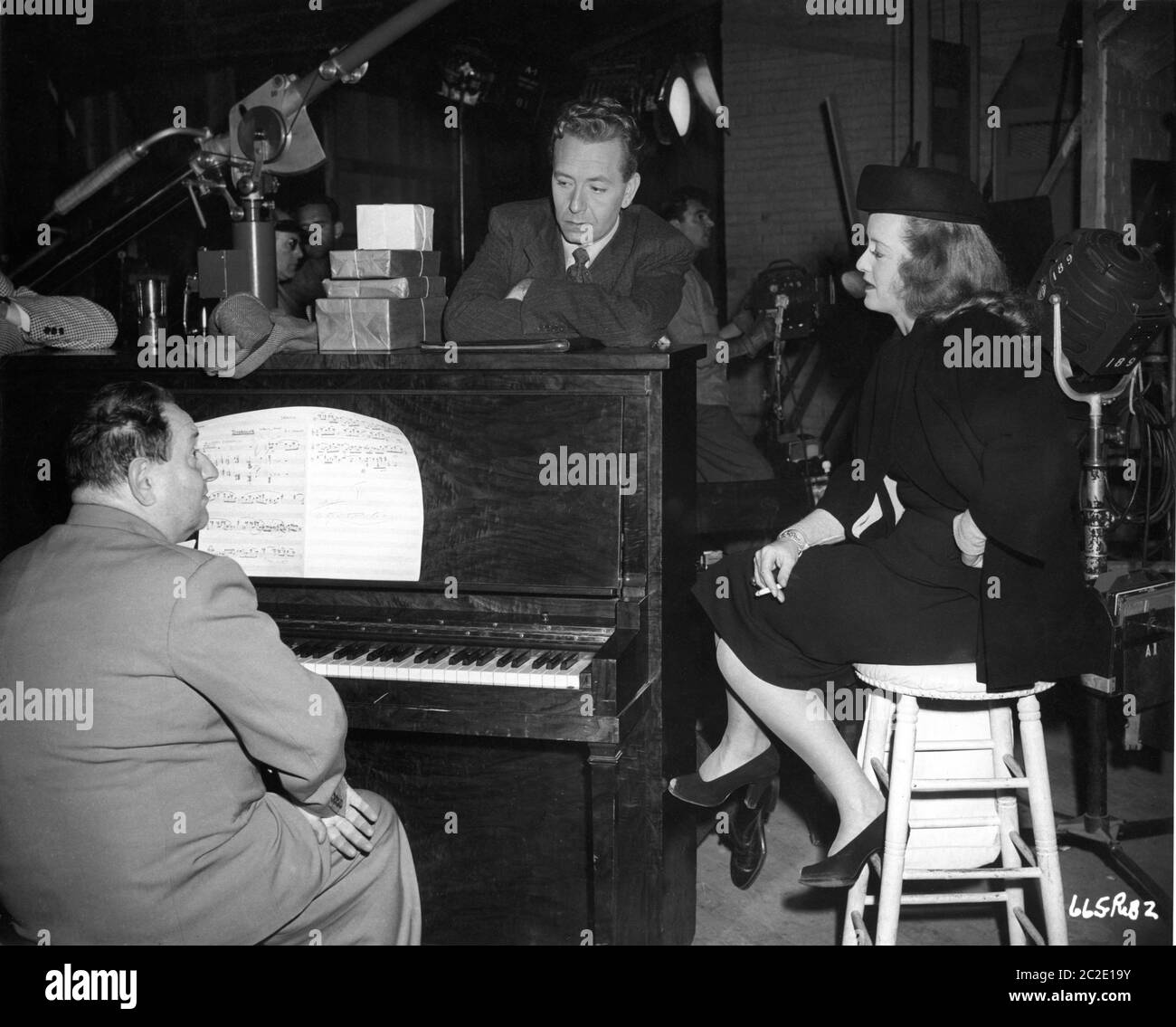 Film Composer ERICH WOLFGANG KORNGOLD at piano PAUL HENRIED and BETTE ...