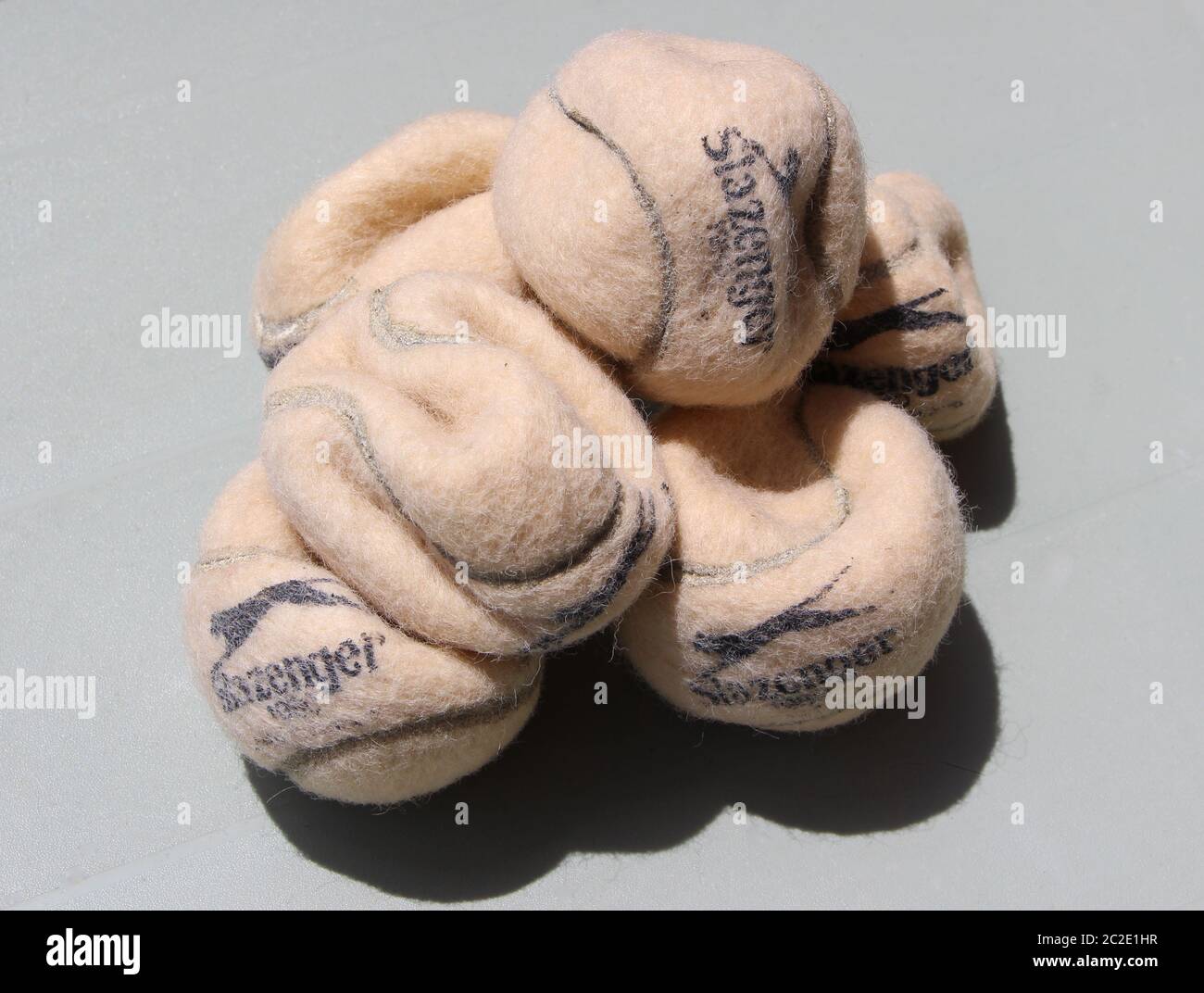 Six old destroyed Slazenger tennis balls piled up Stock Photo - Alamy
