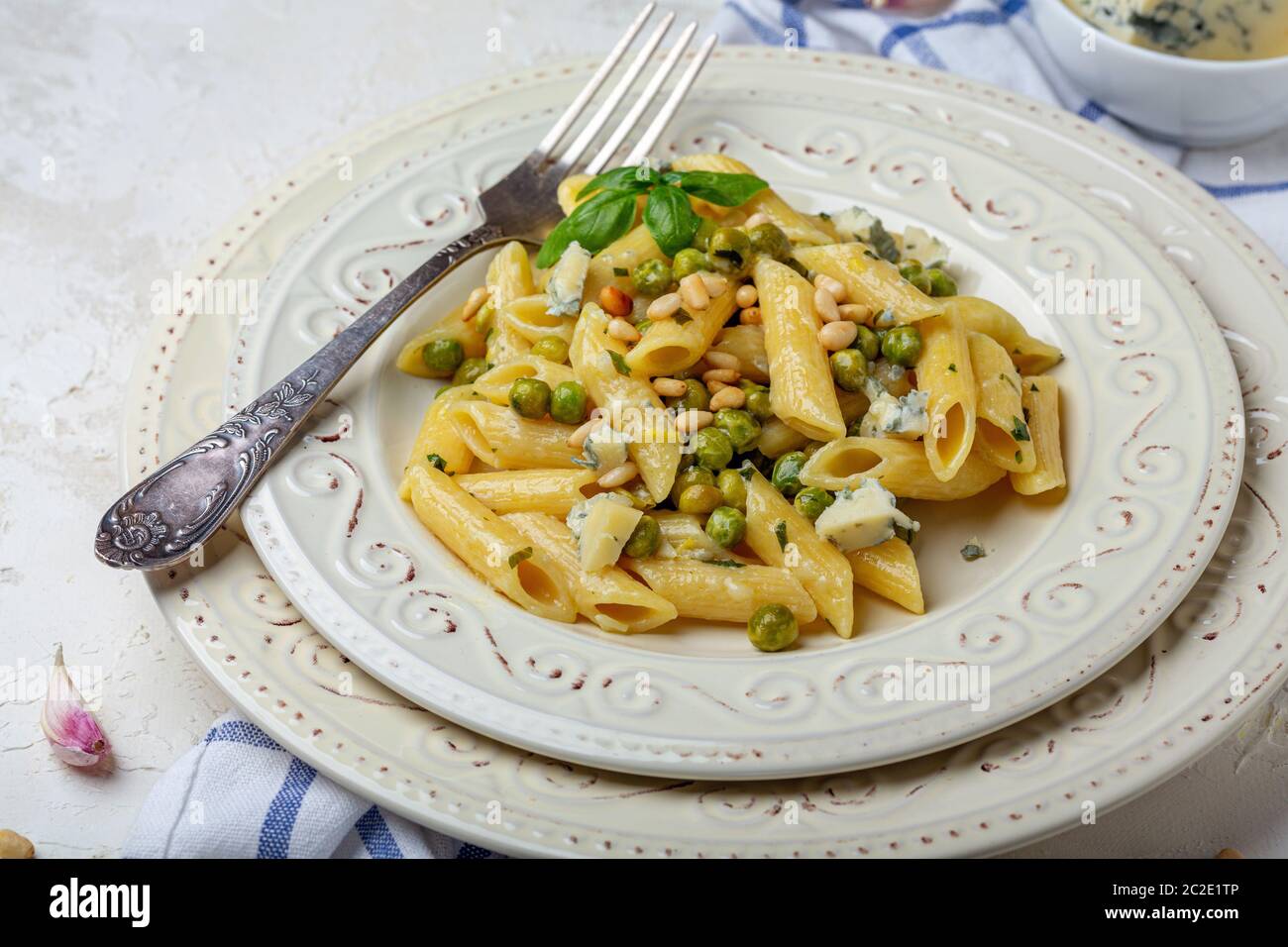 Italian pasta with green peas and blue cheese Stock Photo - Alamy