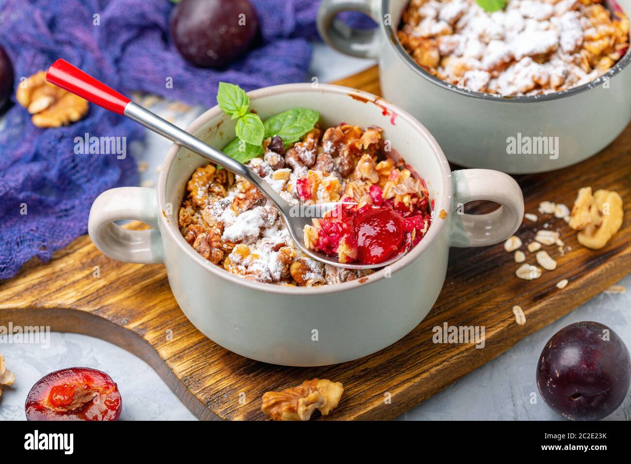 Red cherry plum crumble with walnut crumb Stock Photo - Alamy