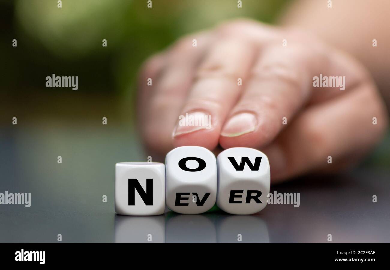 Now or never? Hand turns dice and changes the word "never" to "now ...