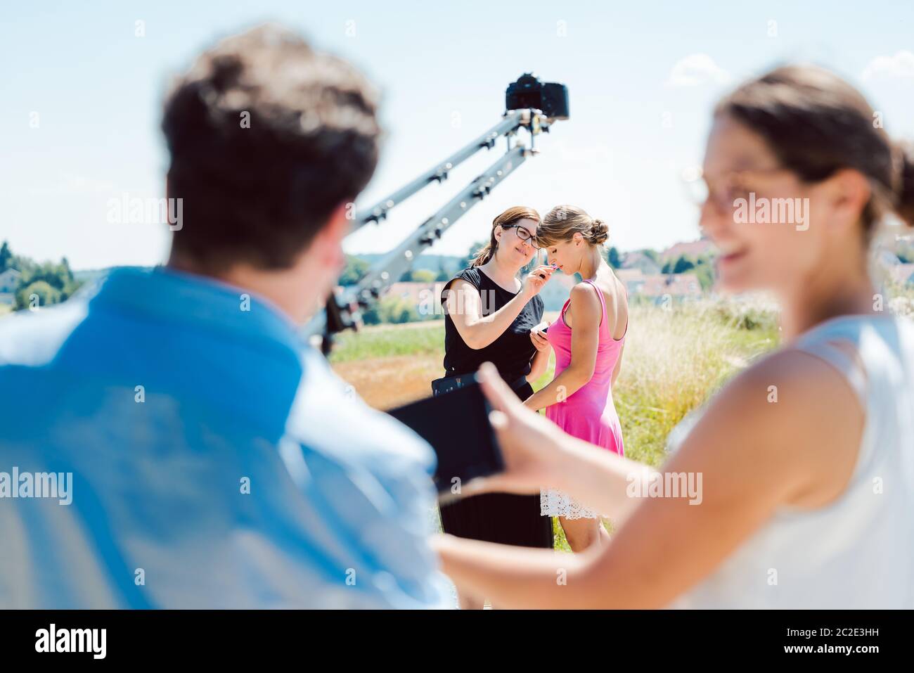 Cameraman with camera on a crane on video production set while model is ...