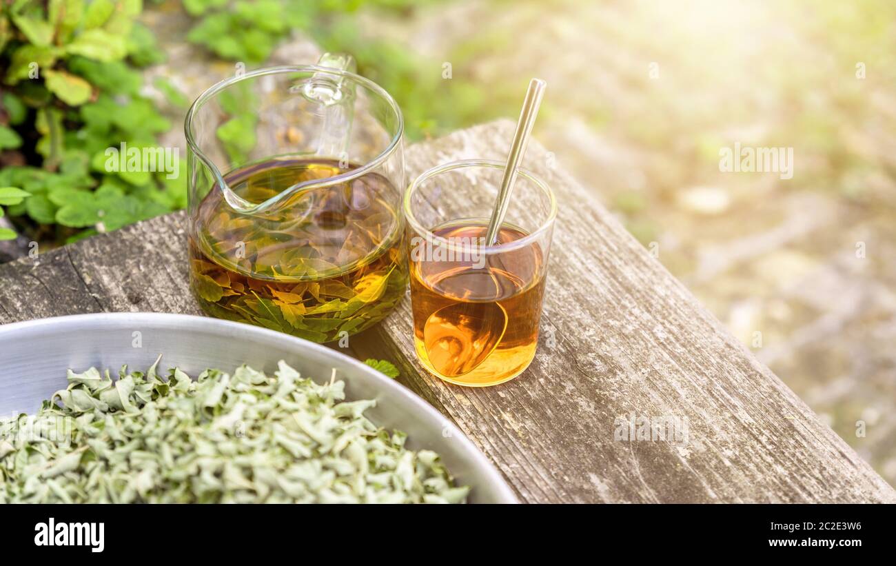 verbena tea on old wooden planks Stock Photo - Alamy