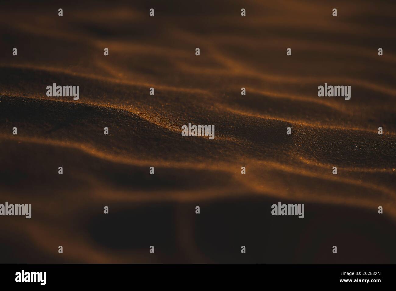 Patterns in sand on a beach with moody light at sunset Stock Photo - Alamy