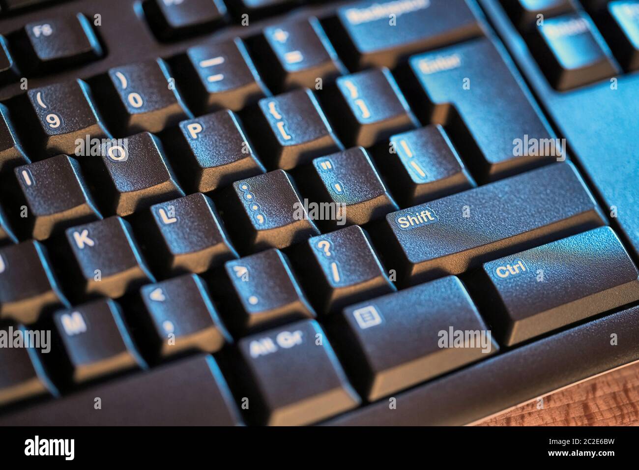 Detail of a black keyboard in blue light Stock Photo - Alamy