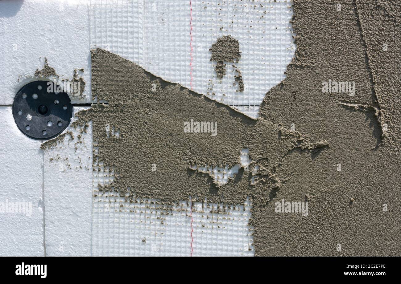 Insulation from expanded polystyrene, plaster, mesh and plastic dowel ...