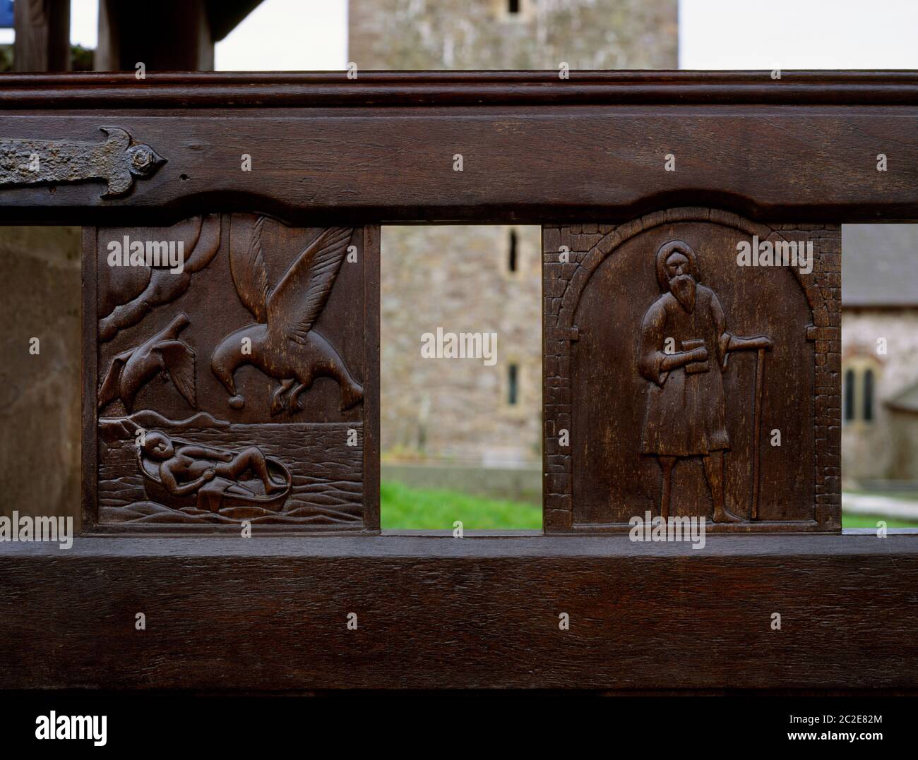 Scenes from the Life of St Kyned (Cenydd) carved on the modern wooden ...