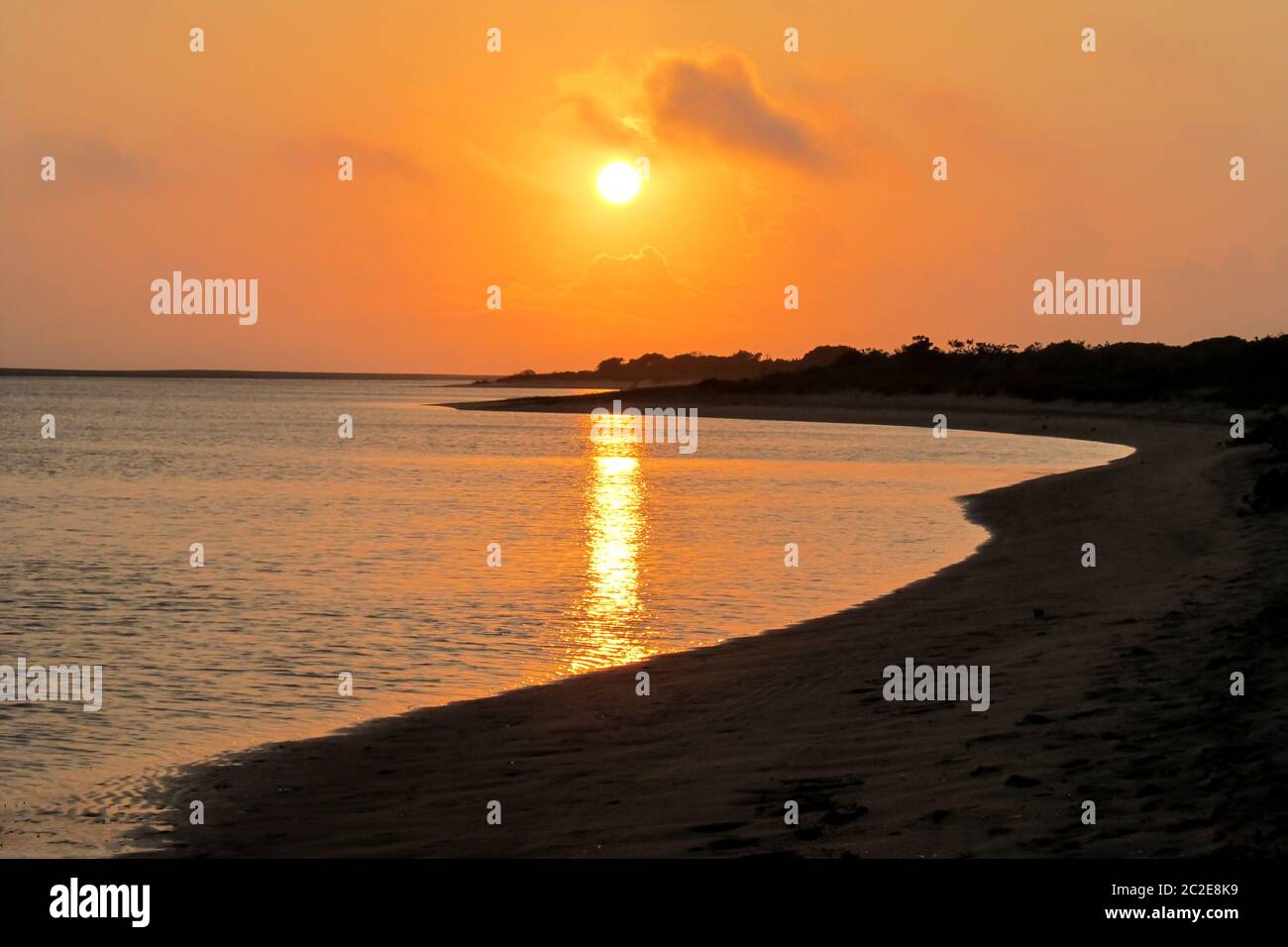 Sunrise, reflecting in a quiet, secluded bay at Portuguese Island, part ...