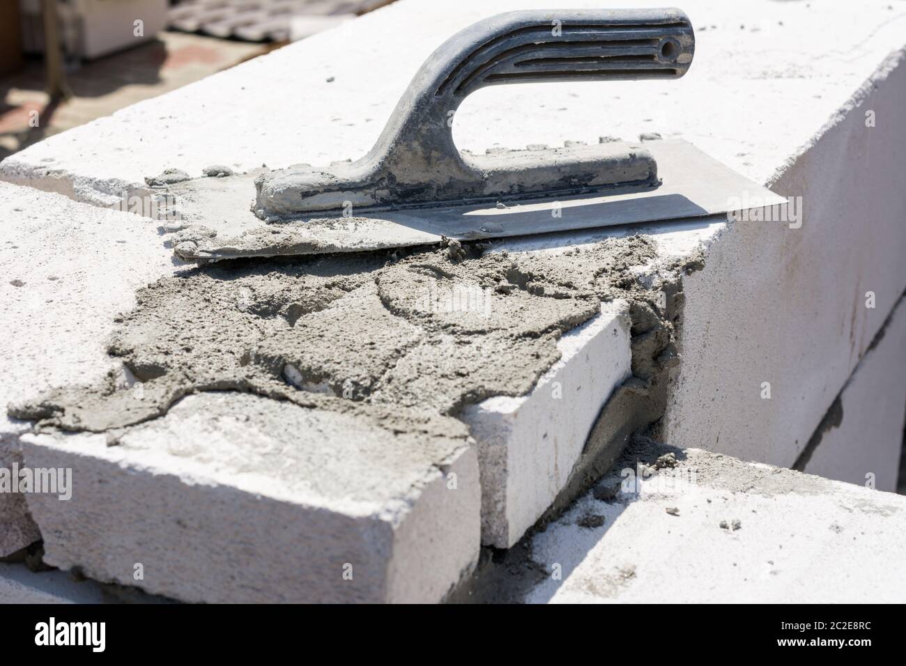 Mason float and mortar on lightweight concrete blocks. Concept for ...