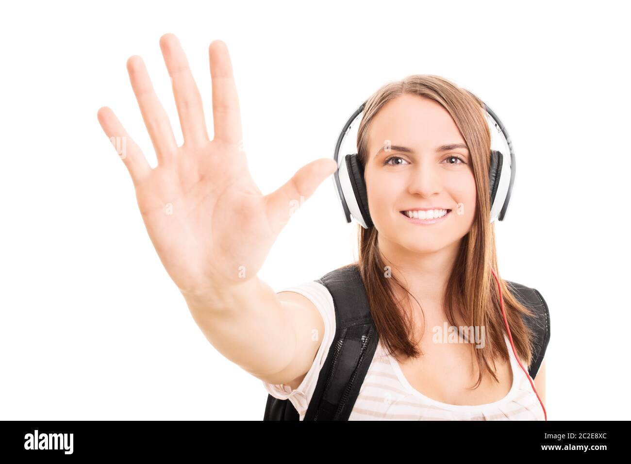 Beautiful smiling young student girl with headphones holding her hand ...
