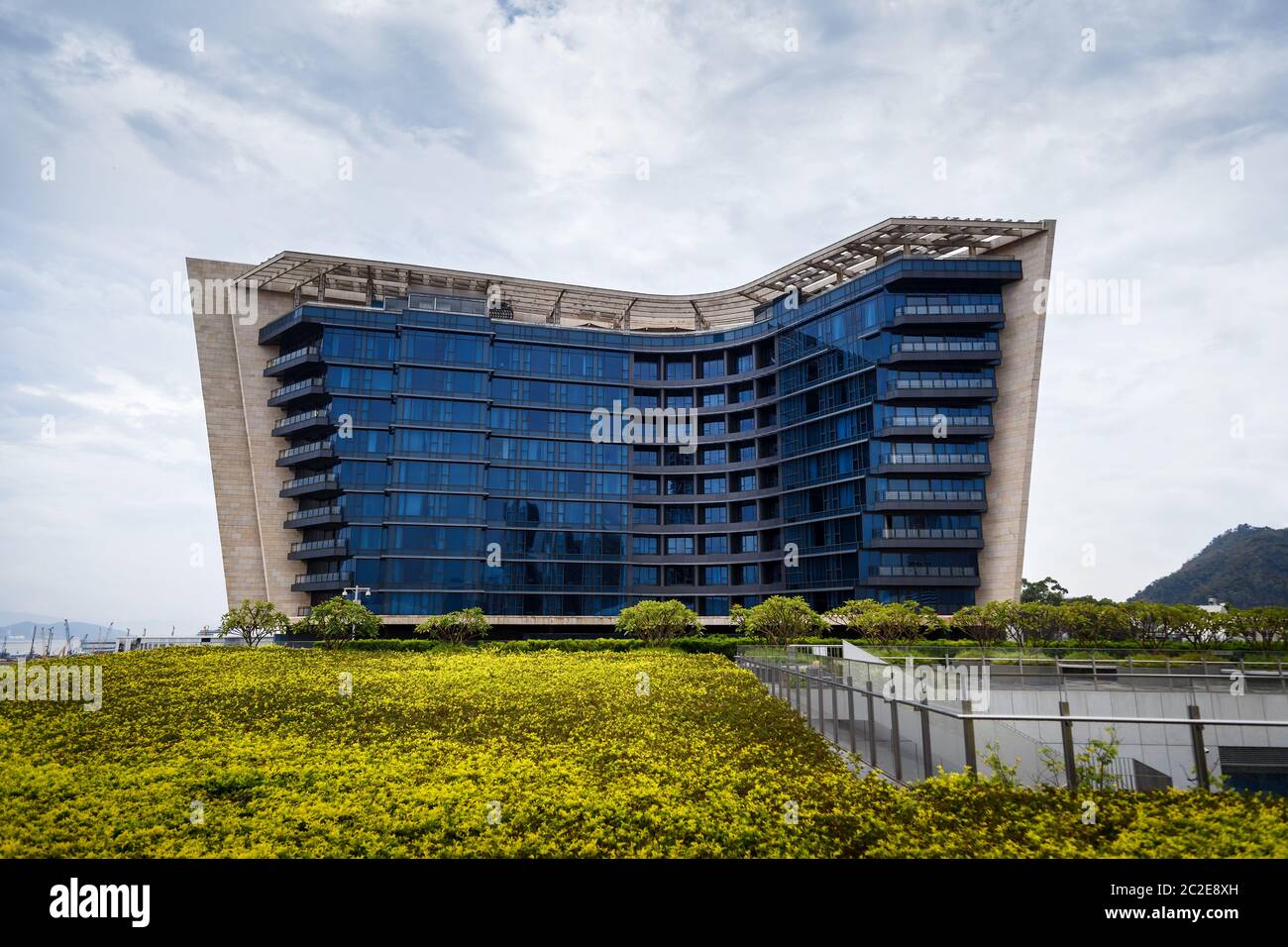 High-rise building in a metropolis of unusual shape made of glass and ...