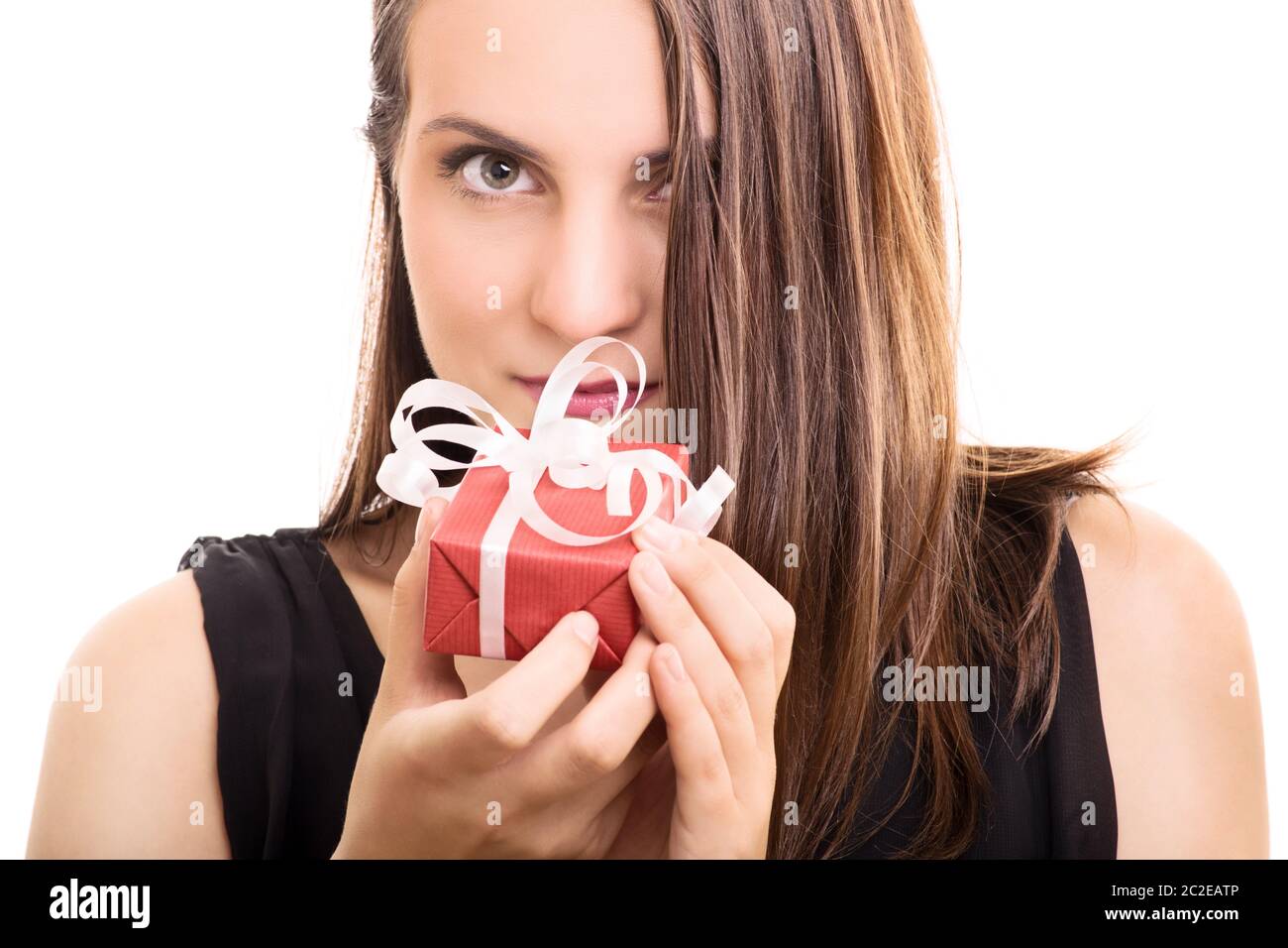 Close-up shot of a beautiful young woman holding a gift, making an ...