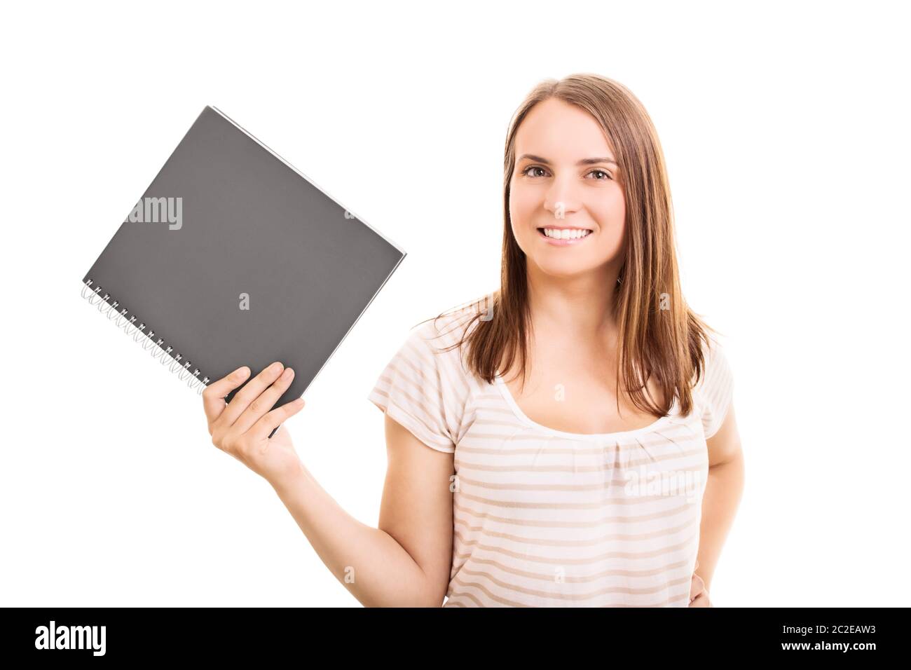 Smiling young student girl holding a notebook, isolated on white ...
